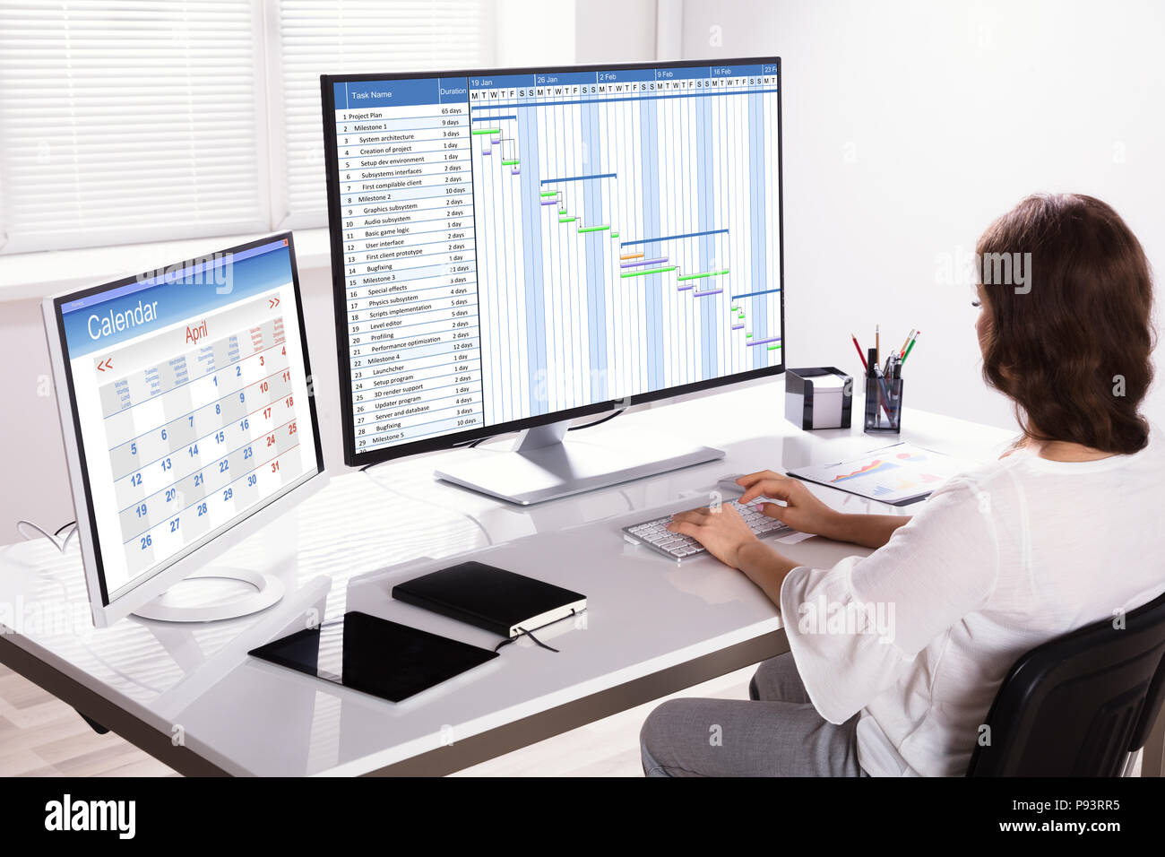Young Businesswoman Analyzing Gantt Chart On Computer In Office Stock ...