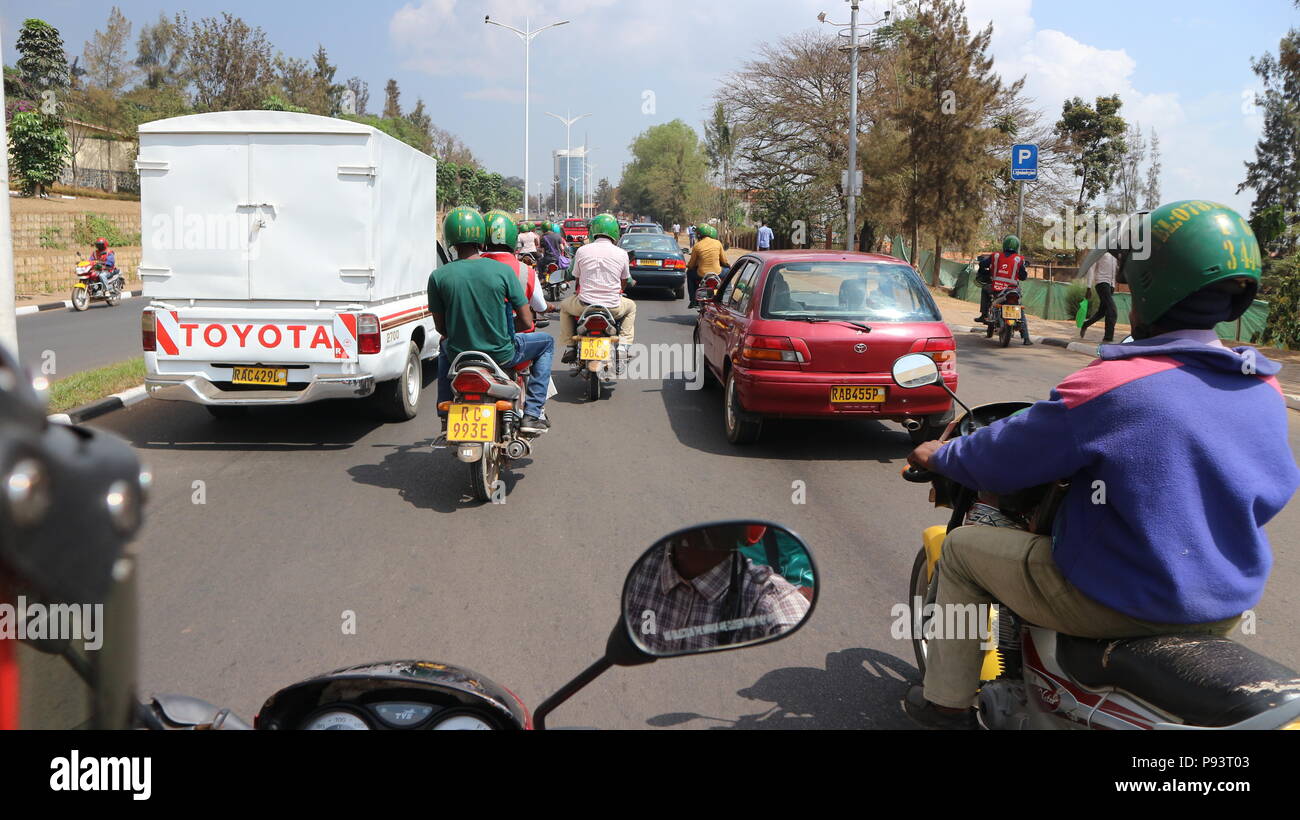 Road traffic in Kigali, Rwanda, Africa viewed from the back of a motor ...