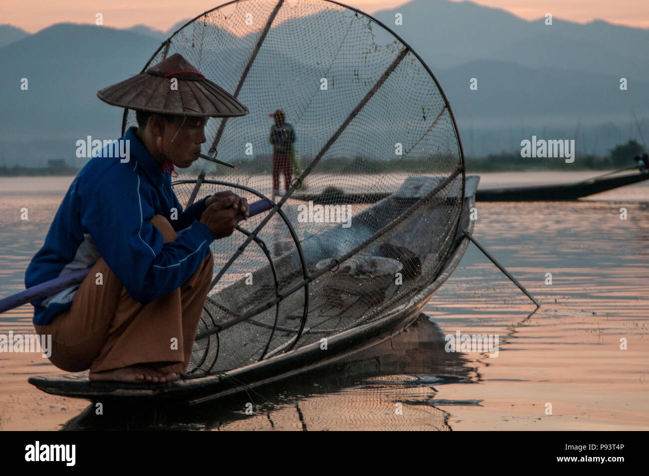 Traditional fishing during sunrise at Inle Lake Stock Photo - Alamy
