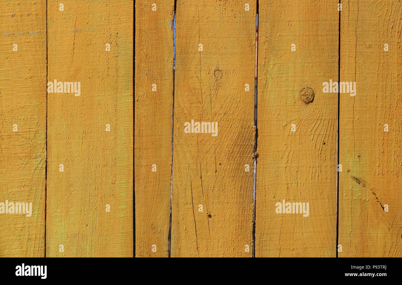 Close up background texture of yellow rustic painted wooden planks ...