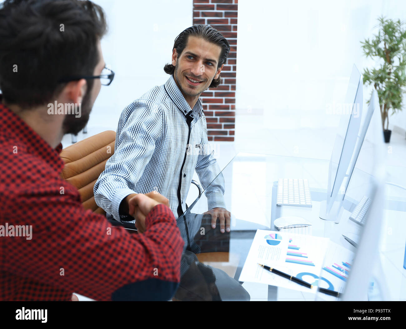 Two men handshake in the office Stock Photo - Alamy
