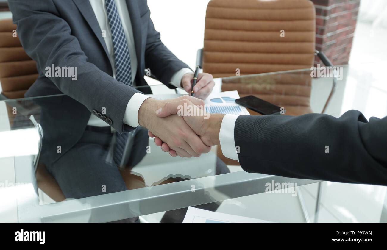 financial partners handshake after signing contract Stock Photo - Alamy
