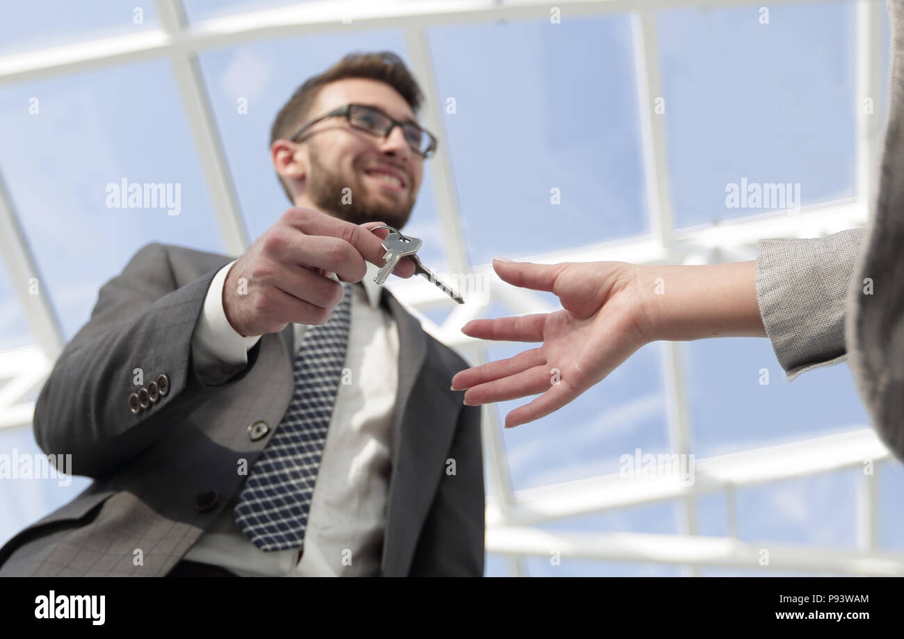 Cropped image of estate agent giving house keys to man in office Stock ...