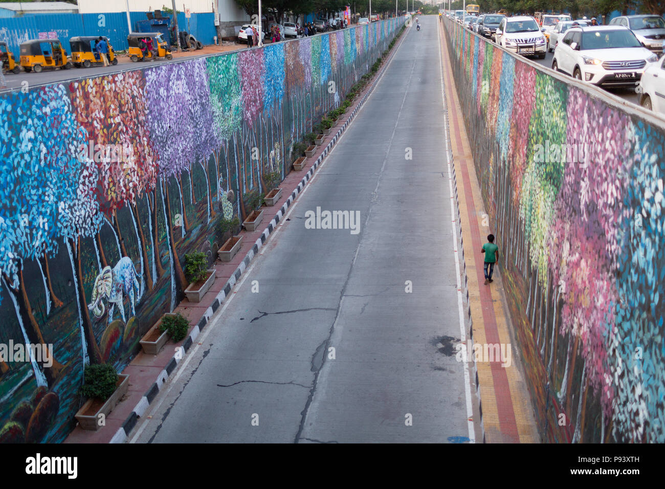 Pedestrians walk on the sidewalk on the recently built underpass in ...