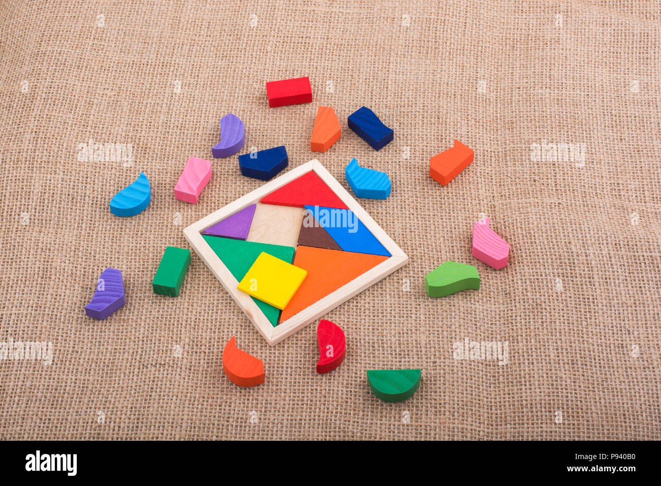 Colorful pieces of a square tangram puzzle Stock Photo - Alamy