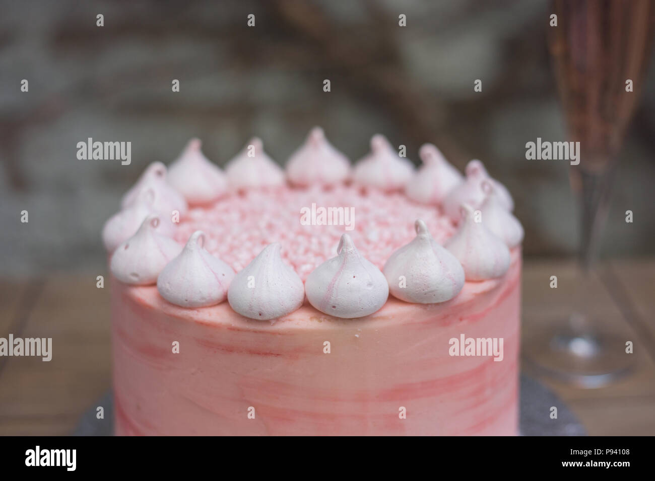 Pink Champagne Cake with mini pink meringues on top, covered with ...
