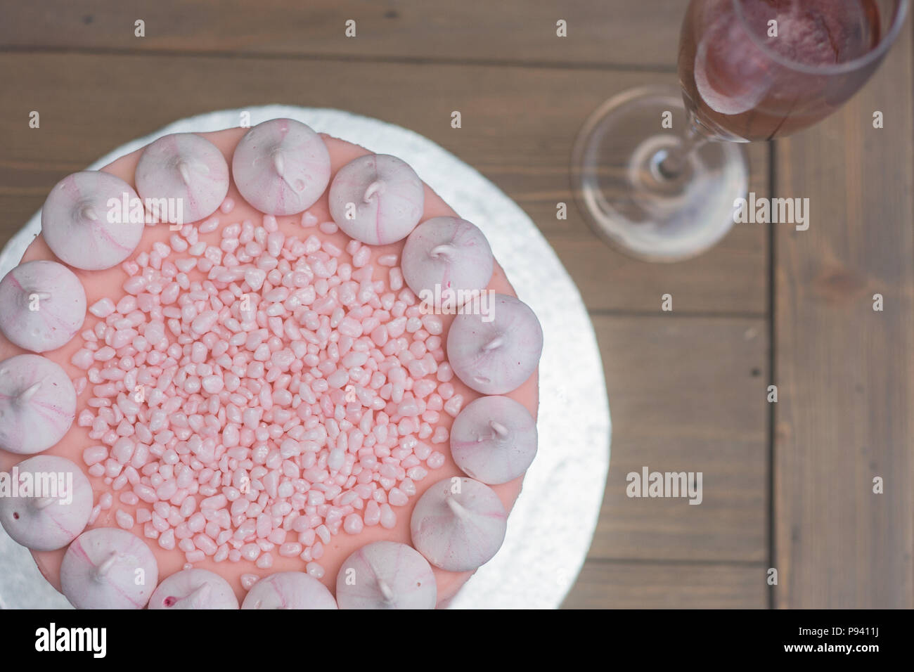 Pink Champagne Cake with mini pink meringues on top, covered with ...