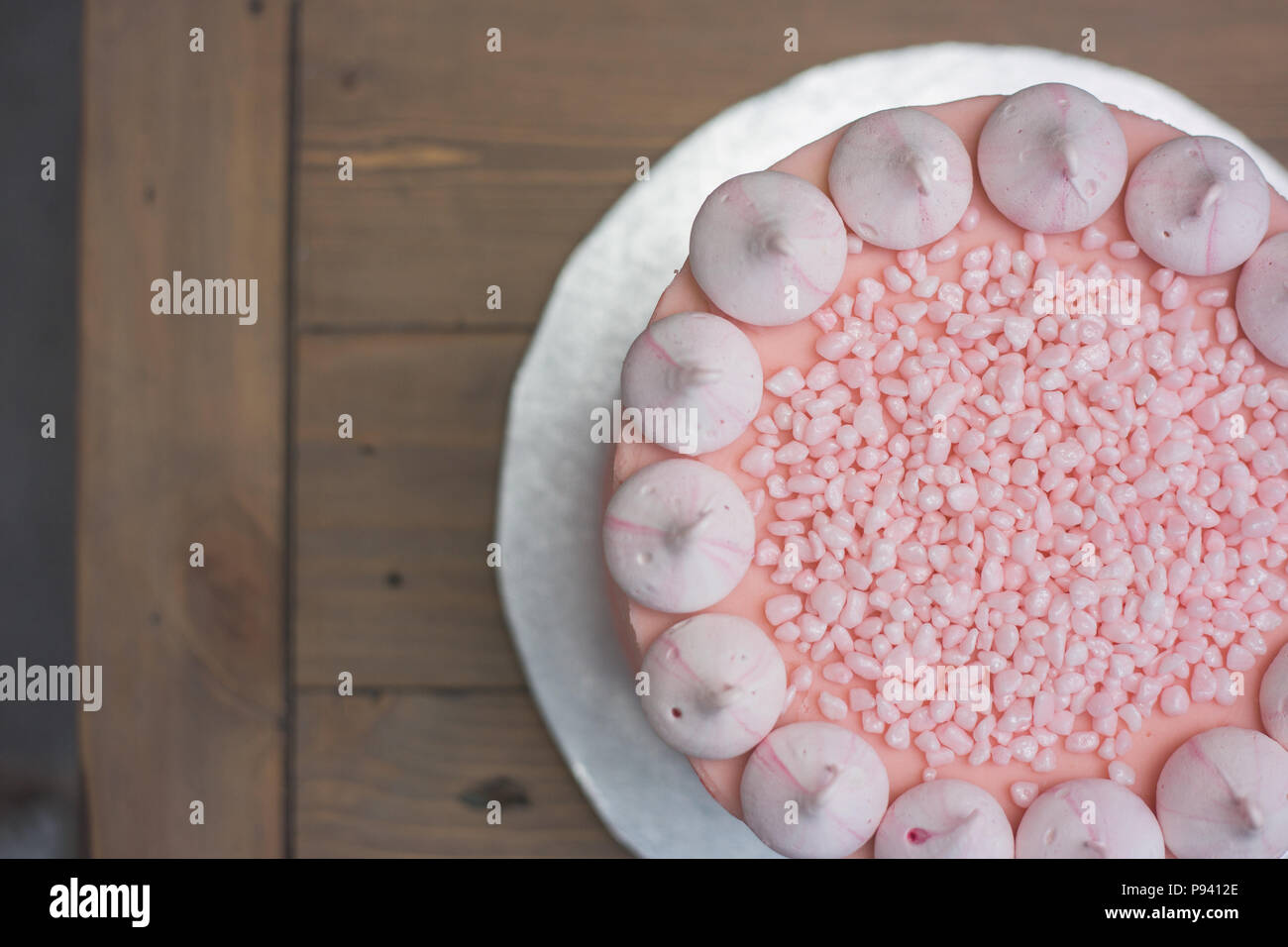 Pink Champagne Cake with mini pink meringues on top, covered with ...