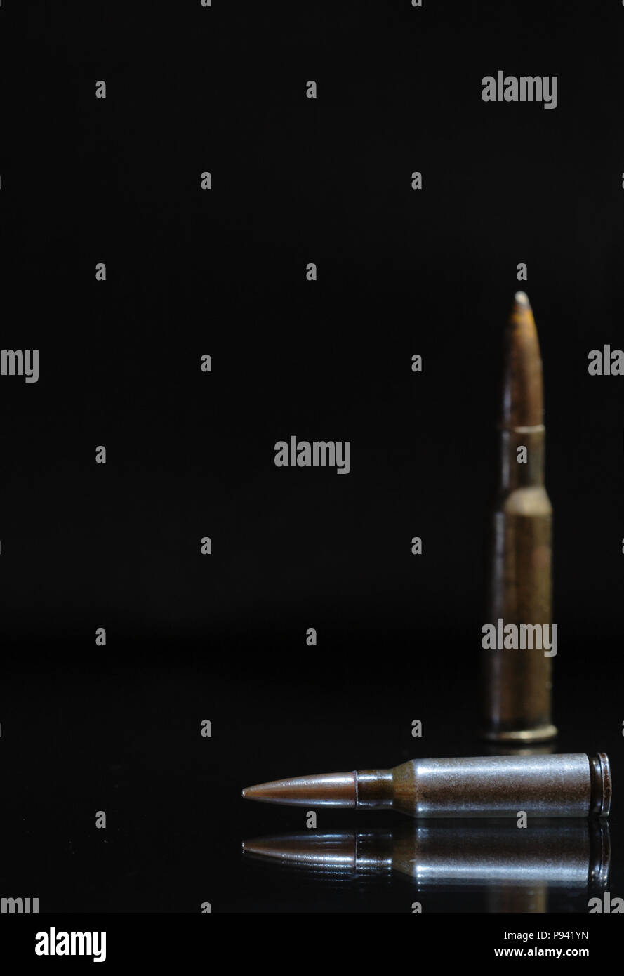 Two high power rifle cartridges on a dark background with copy space ...