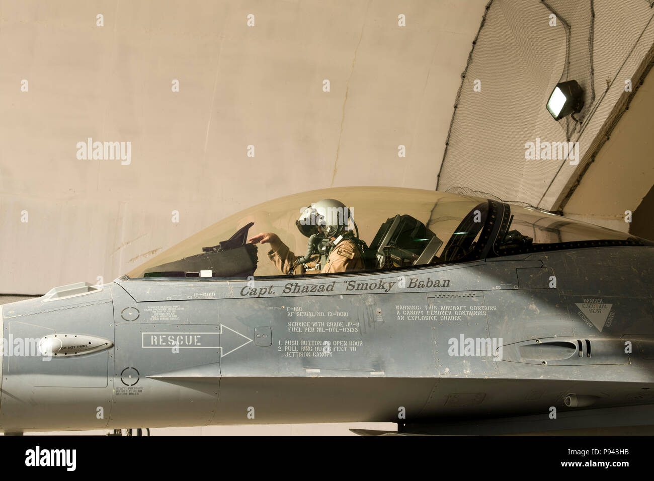 An Iraqi F-16 Fighting Falcon pilot performs his pre-flight checklist ...