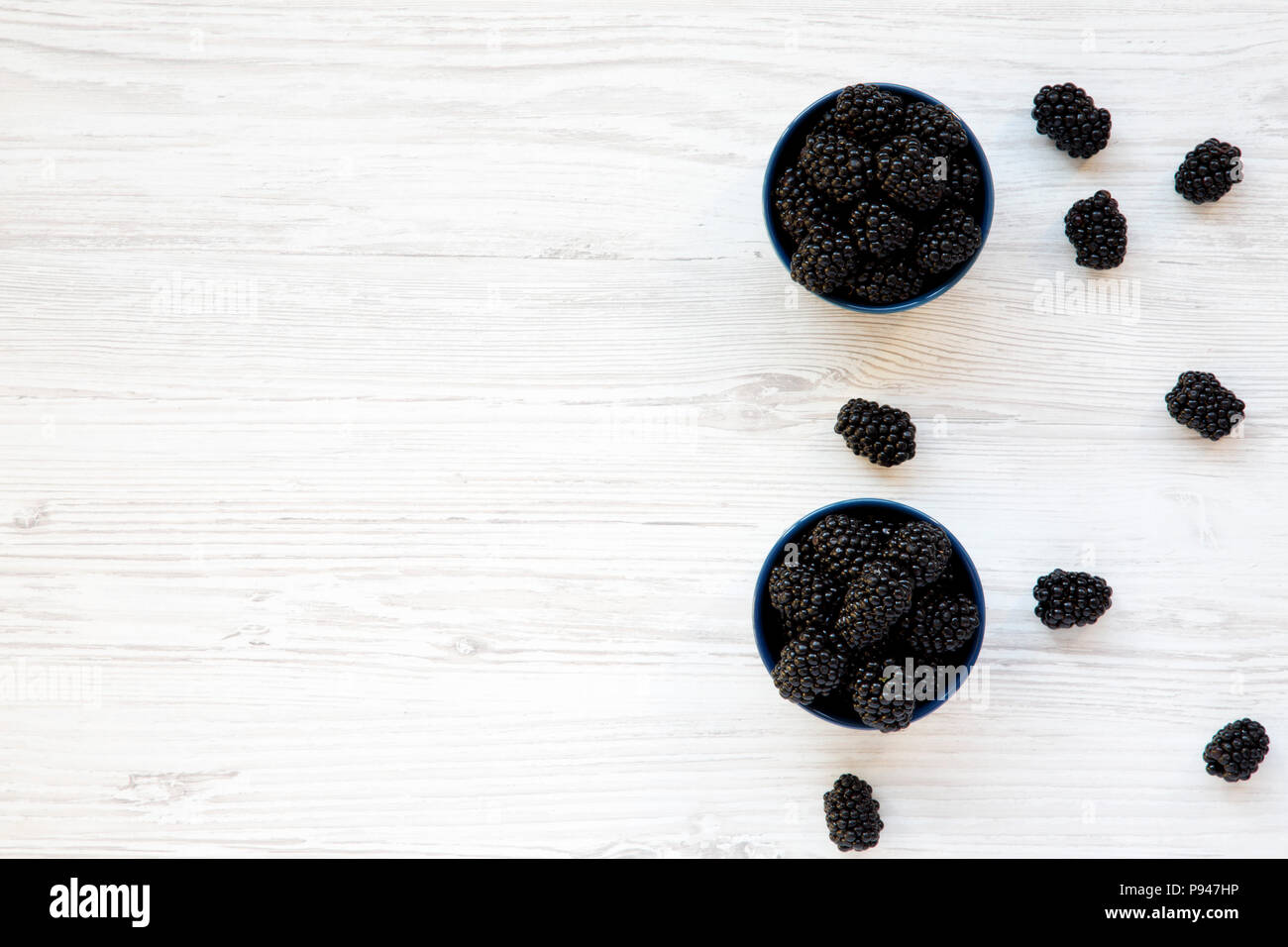 Full ceramic bowls of blackberries, top view. Summer berry. From above ...