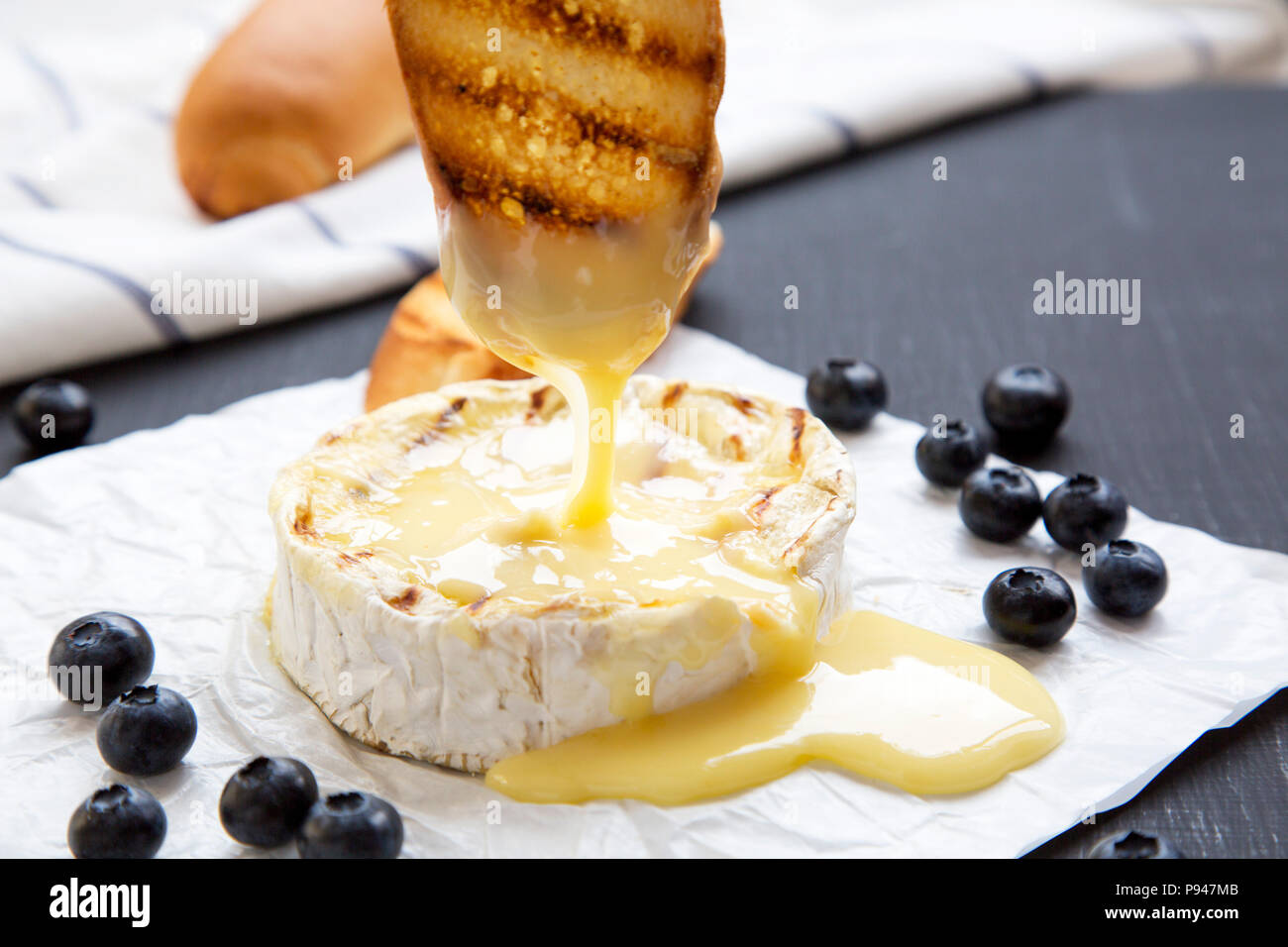 Grilled camembert cheese, side view. Closeup Stock Photo - Alamy