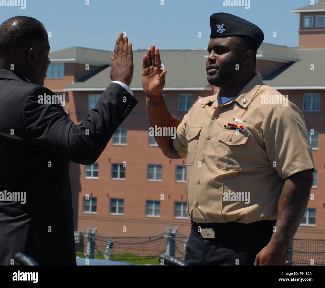 Retired Army Major Frederick Perkins administers the Oath of Re ...