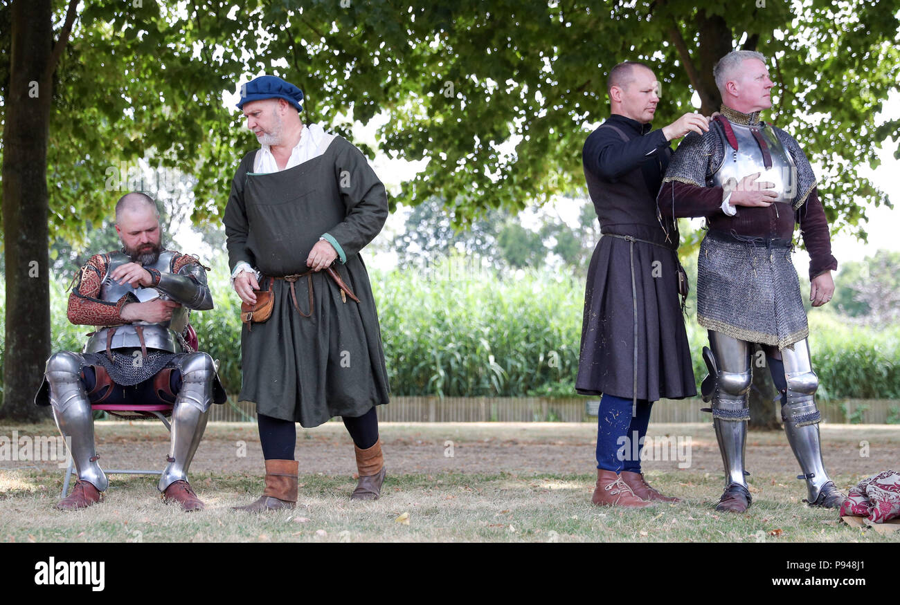 Knights have their armour fitted before the start of the jousting ...