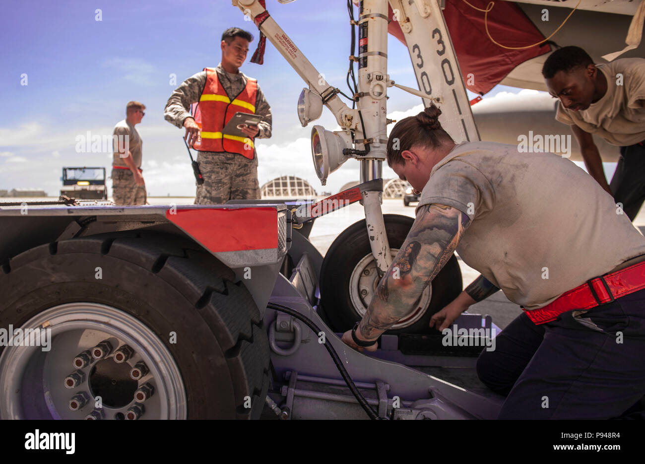 Maintainers from the 18th Aircraft Maintenance Squadron, connect an ...
