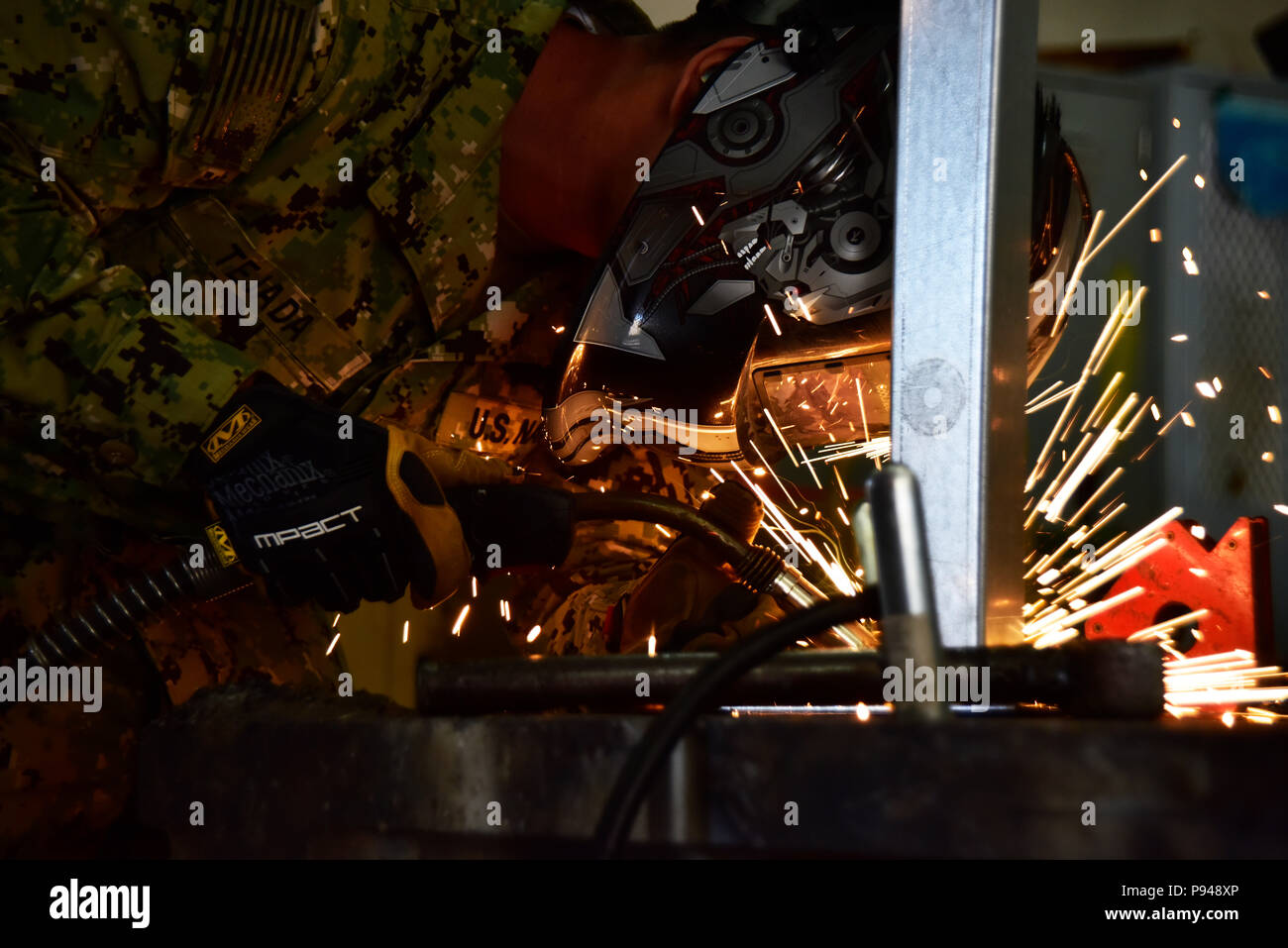 Steelworker 2nd Class Albert Tejada fabricates a sign post out of raw ...