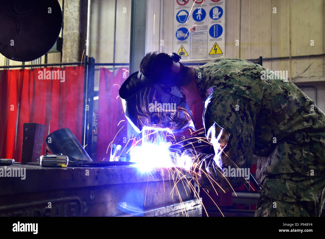 Steelworker 2nd Class Albert Tejada fabricates a sign post out of raw ...