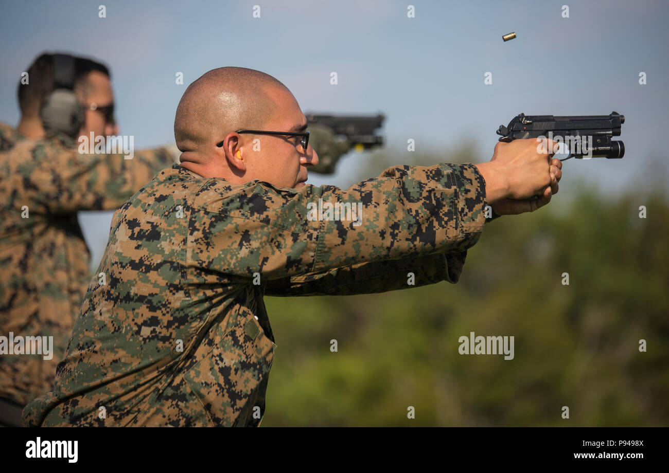 Staff Sgt. Jesus Anchondo, Military Police, executes a pistol shooting ...