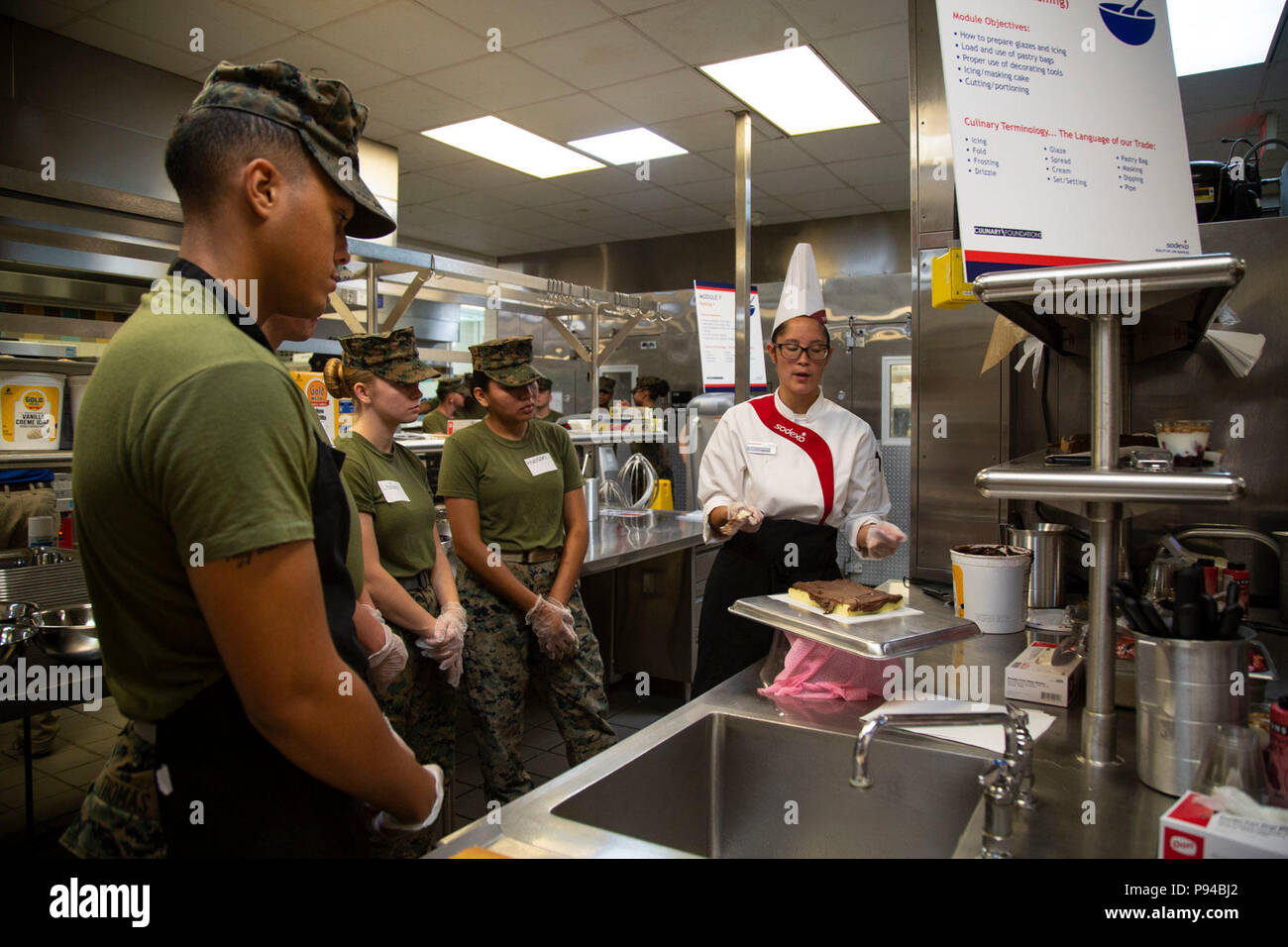 Evangeline Garcia, executive chef, Sodexo, demonstrates cake frosting ...