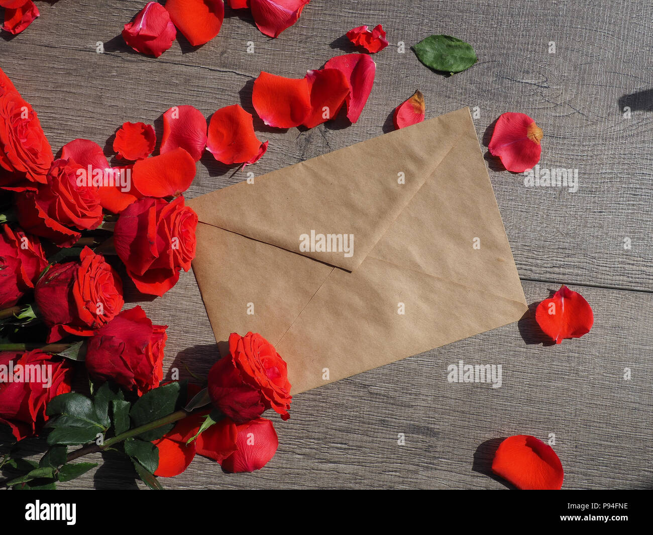 Envelop with white card and rose background. Top view., Envelope with ...