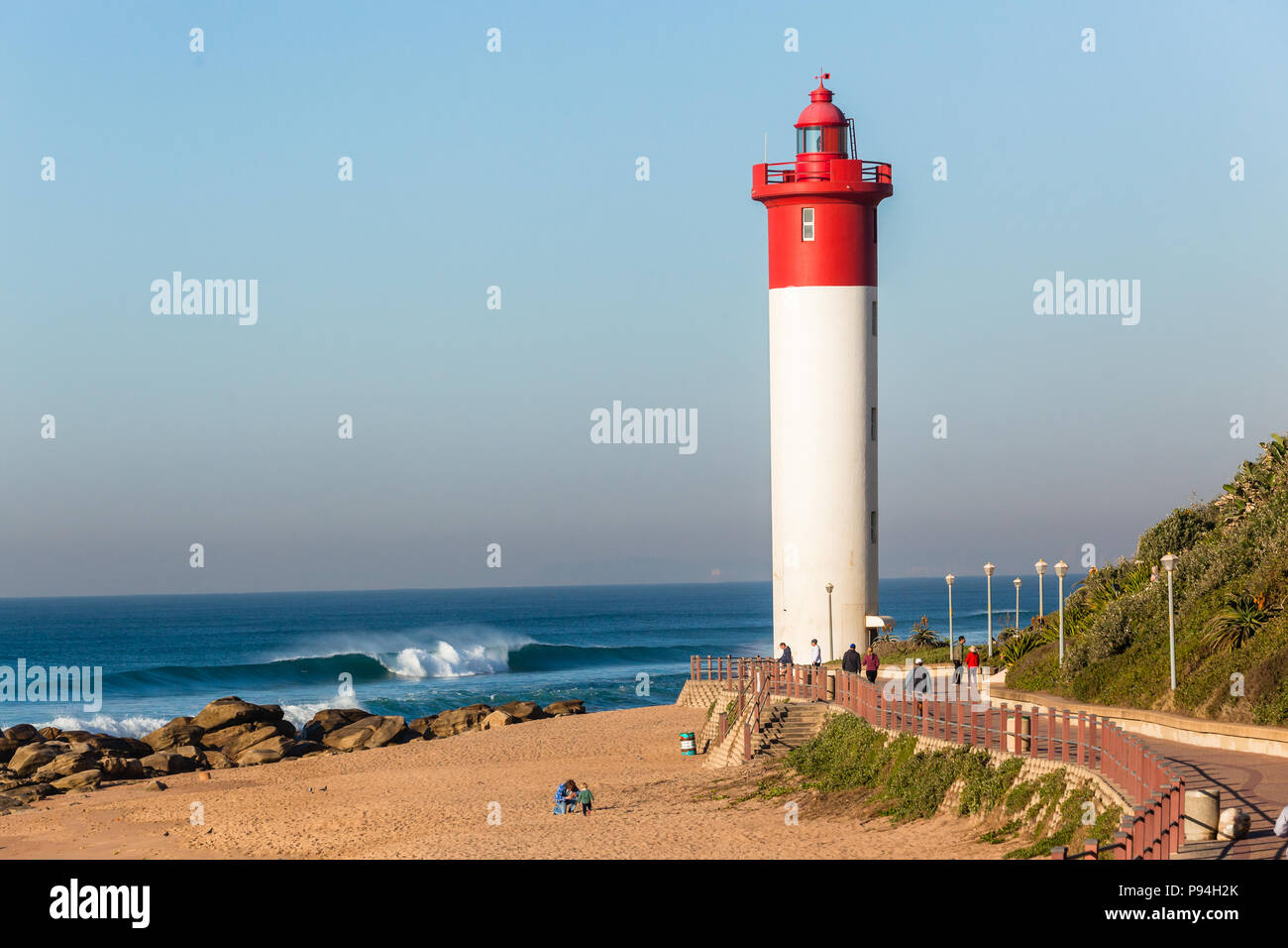 Beach Lighthouse red white structure closeup with blue ocean horizon ...