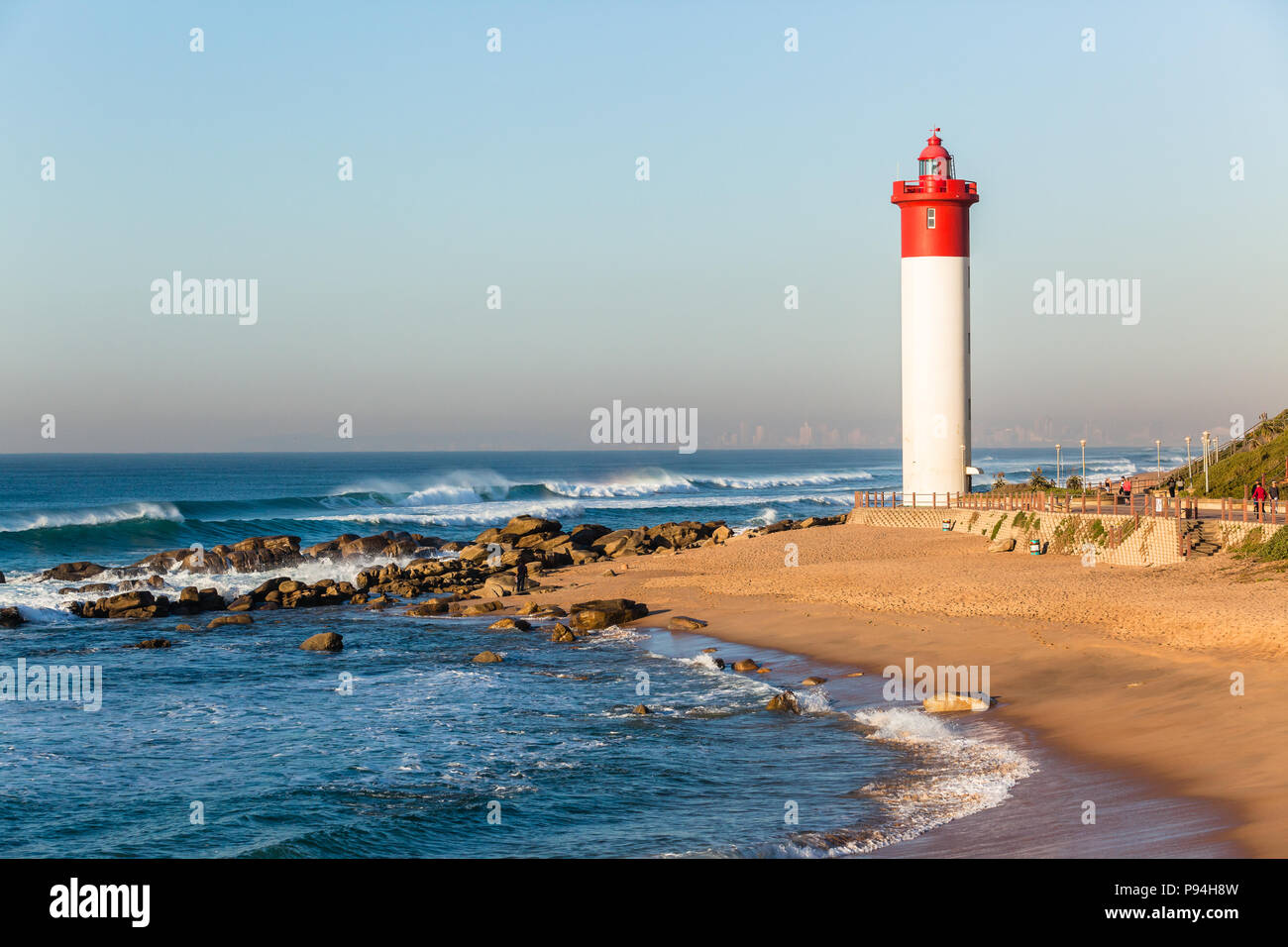 Beach shoreline ocean closeup lighthouse backlight sunlight silhouetted ...