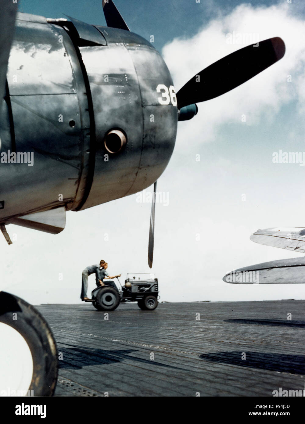 A flight deck tractor races down the flight deck of USS Lexington (CV ...
