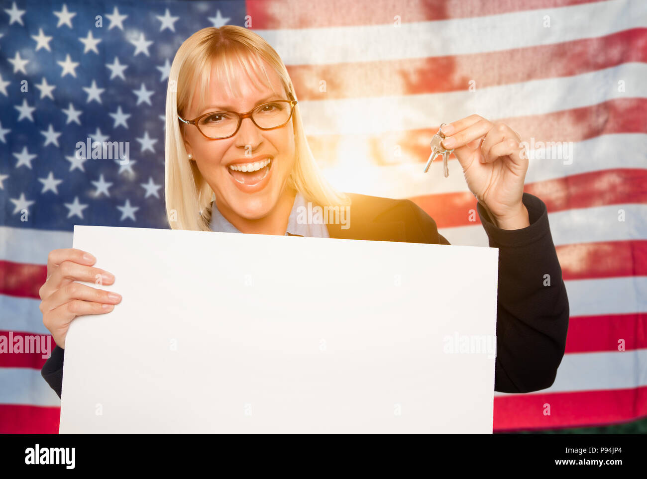 Young Woman Holding House Keys and Blank Sign In Front of American Flag ...