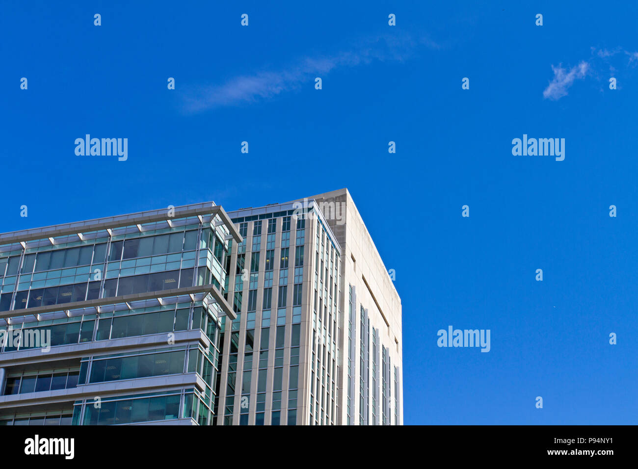 Skyscraper building against blue sky background Stock Photo - Alamy