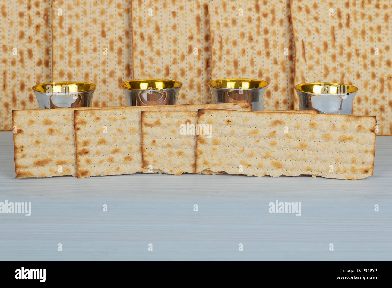 Four cups of Passover wine close up matzah texture Pesah jewish holiday ...