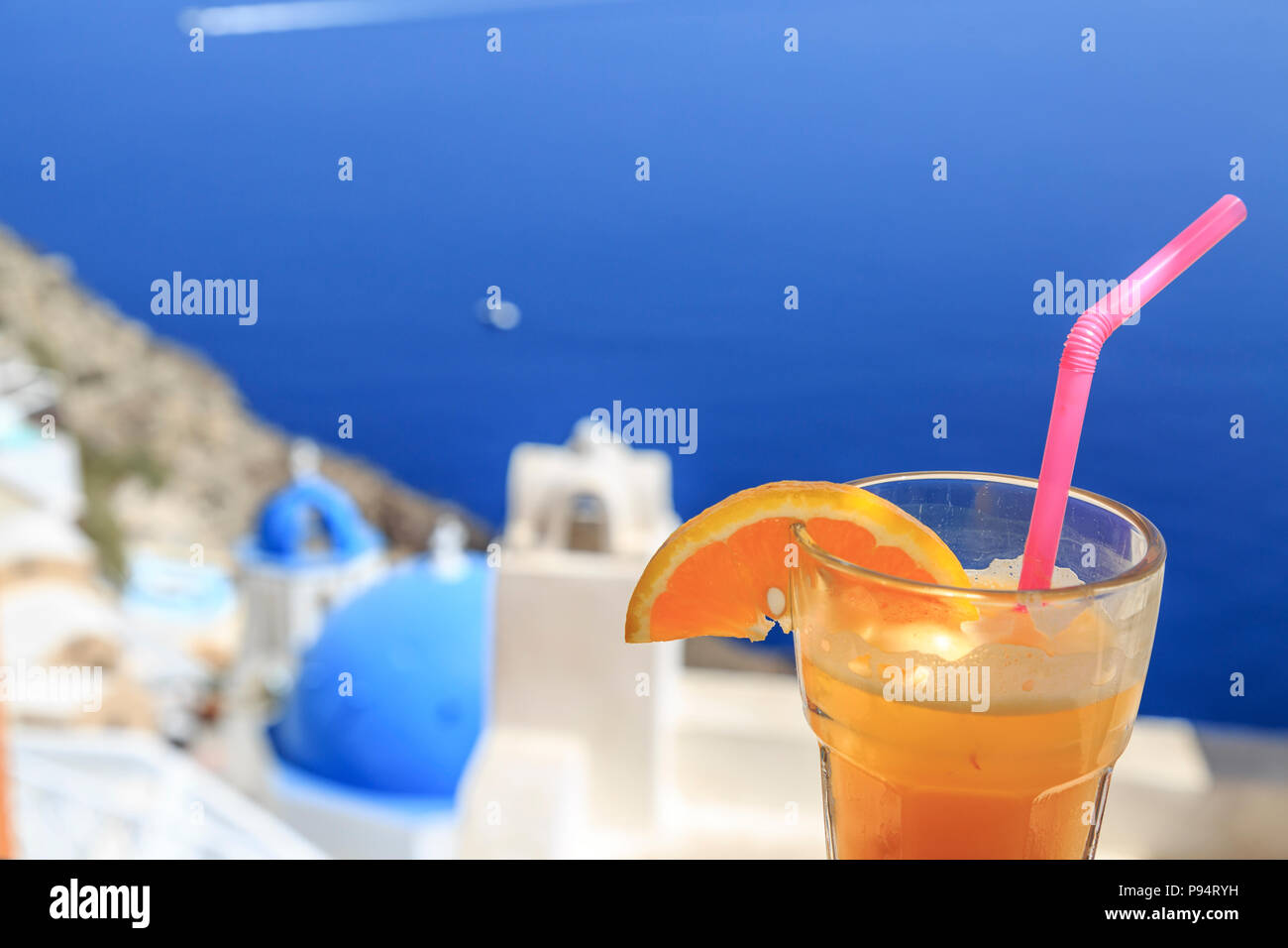 Orange juice with famous church of oia background in Oia, Santorini ...