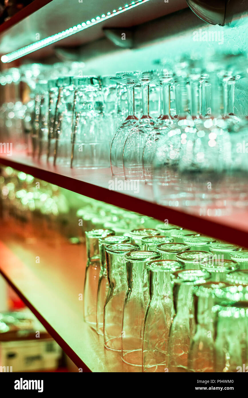 Crystal glass, row and Stack of different glass shelf behind the bar ...