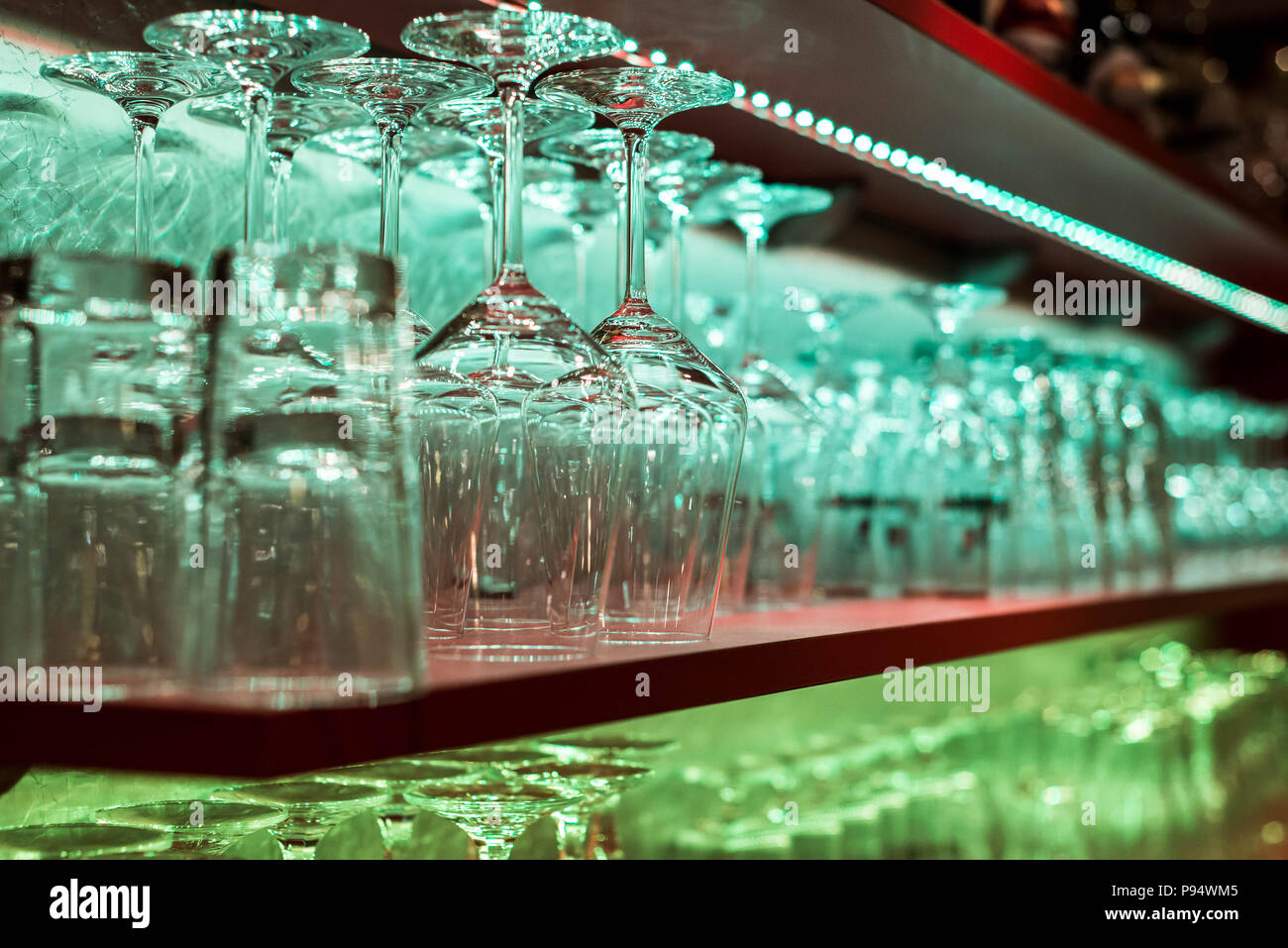 Crystal glass, row and Stack of different glass shelf behind the bar ...