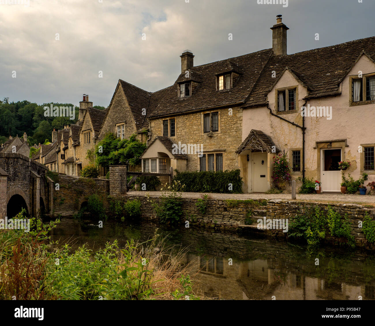 Stone cottages near Bybrook river, Castle Combe, village, Cotswolds ...