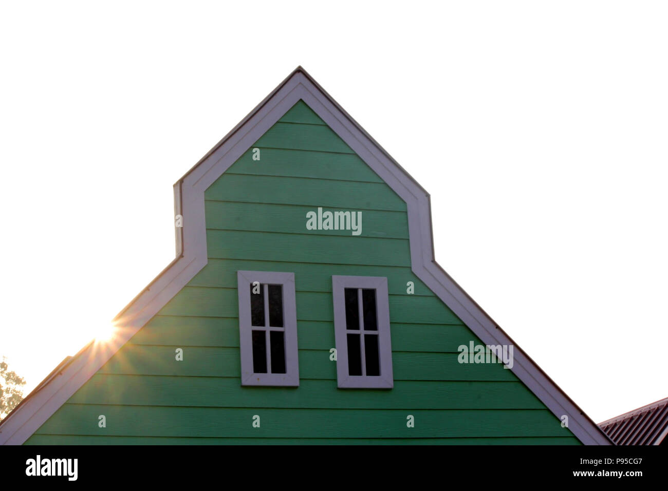 photo of gable roof with white windows on wooden house Stock Photo - Alamy