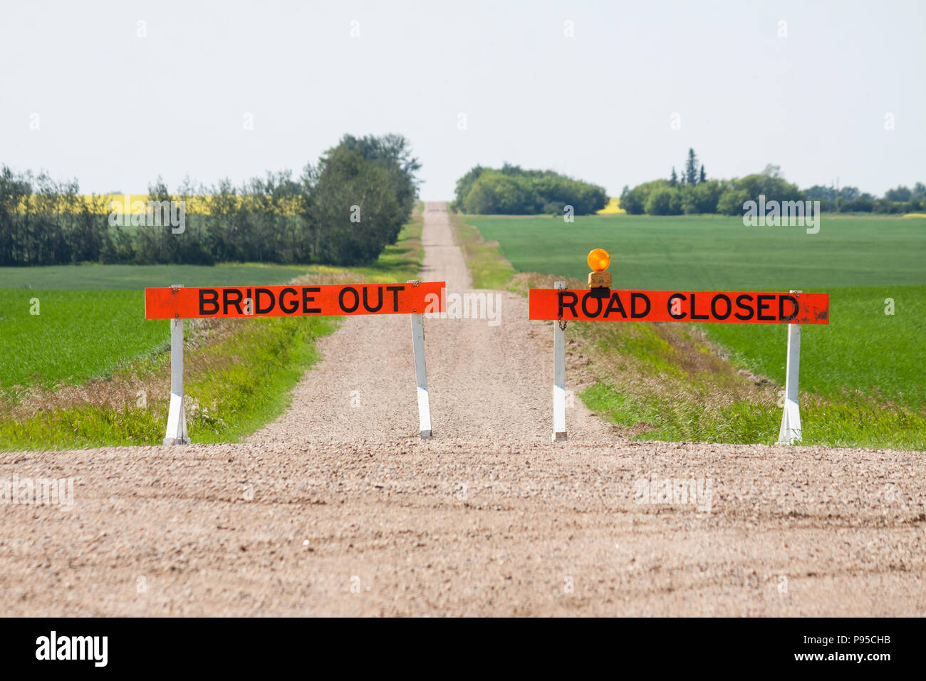 gravel roadwork, Bridge out sign, and road closed sign Stock Photo - Alamy