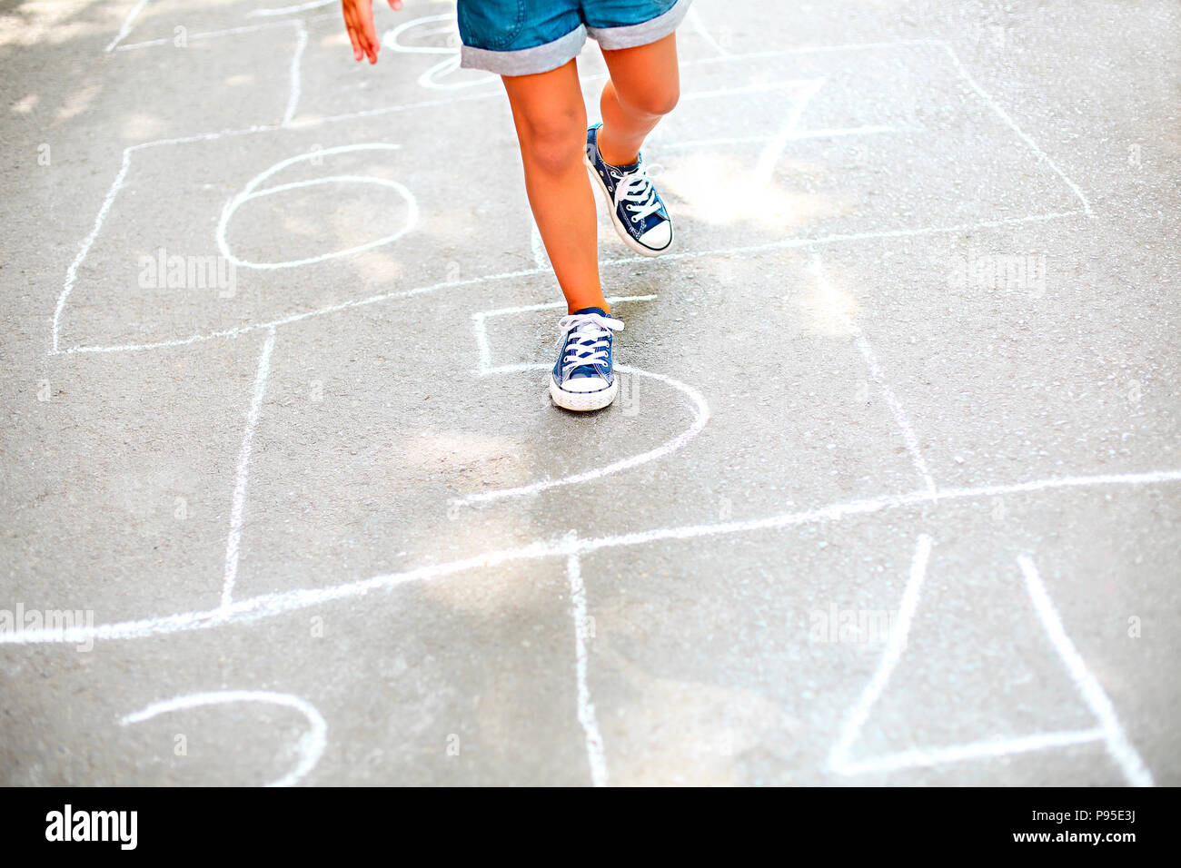 Kid playing hopscotch on playground outdoors, children outdoor ...