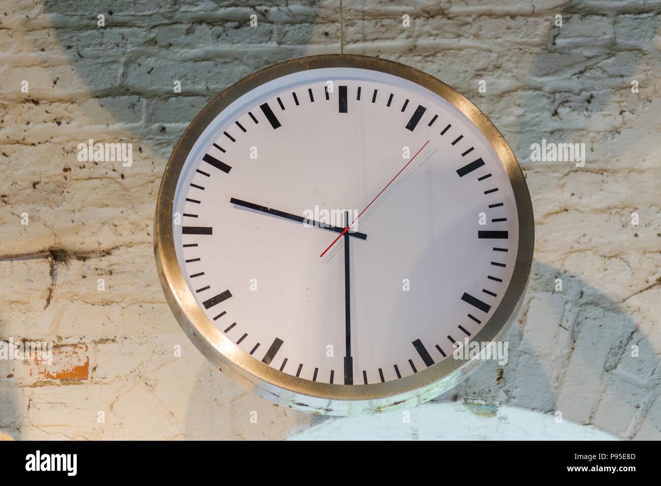 Big old clock in an old factory in front of a window Stock Photo - Alamy