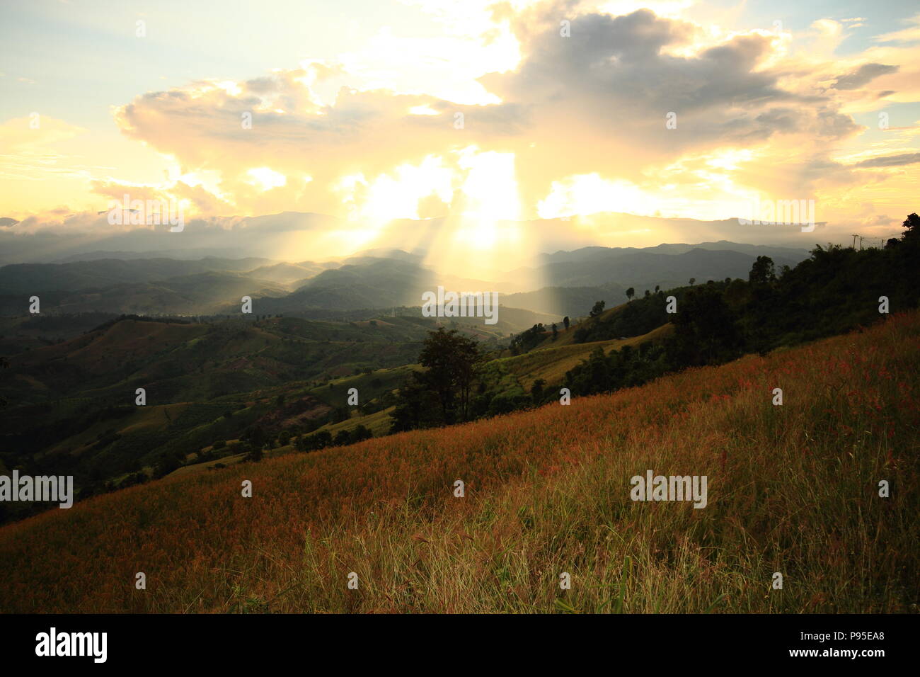 Dramatic god lights passing through clouds and shining on mountain ...