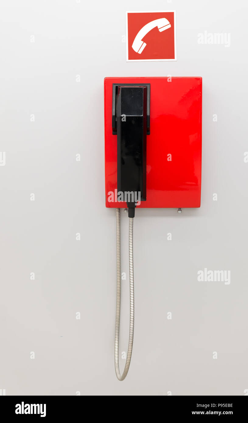 Red vintage telephone hanging on white wall Stock Photo - Alamy