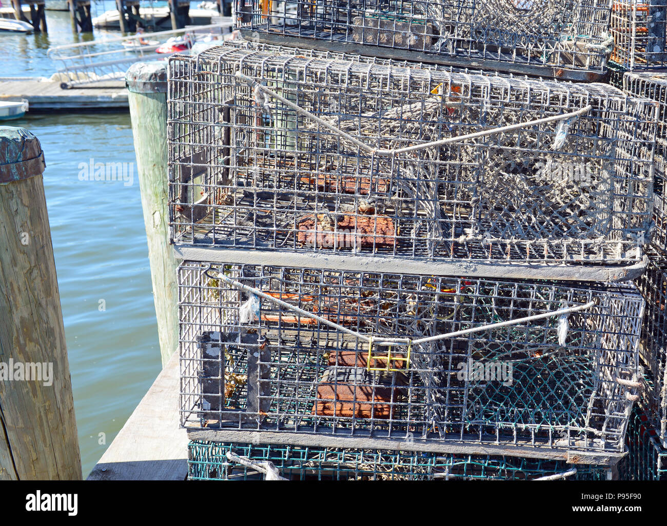 Lobster traps stacked at harbor dock, common coastal scene on the East ...