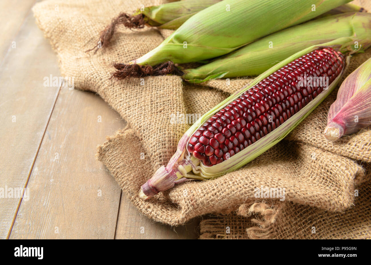 Siam Ruby Queen Corn on wood background, Can be eaten fresh. The taste ...
