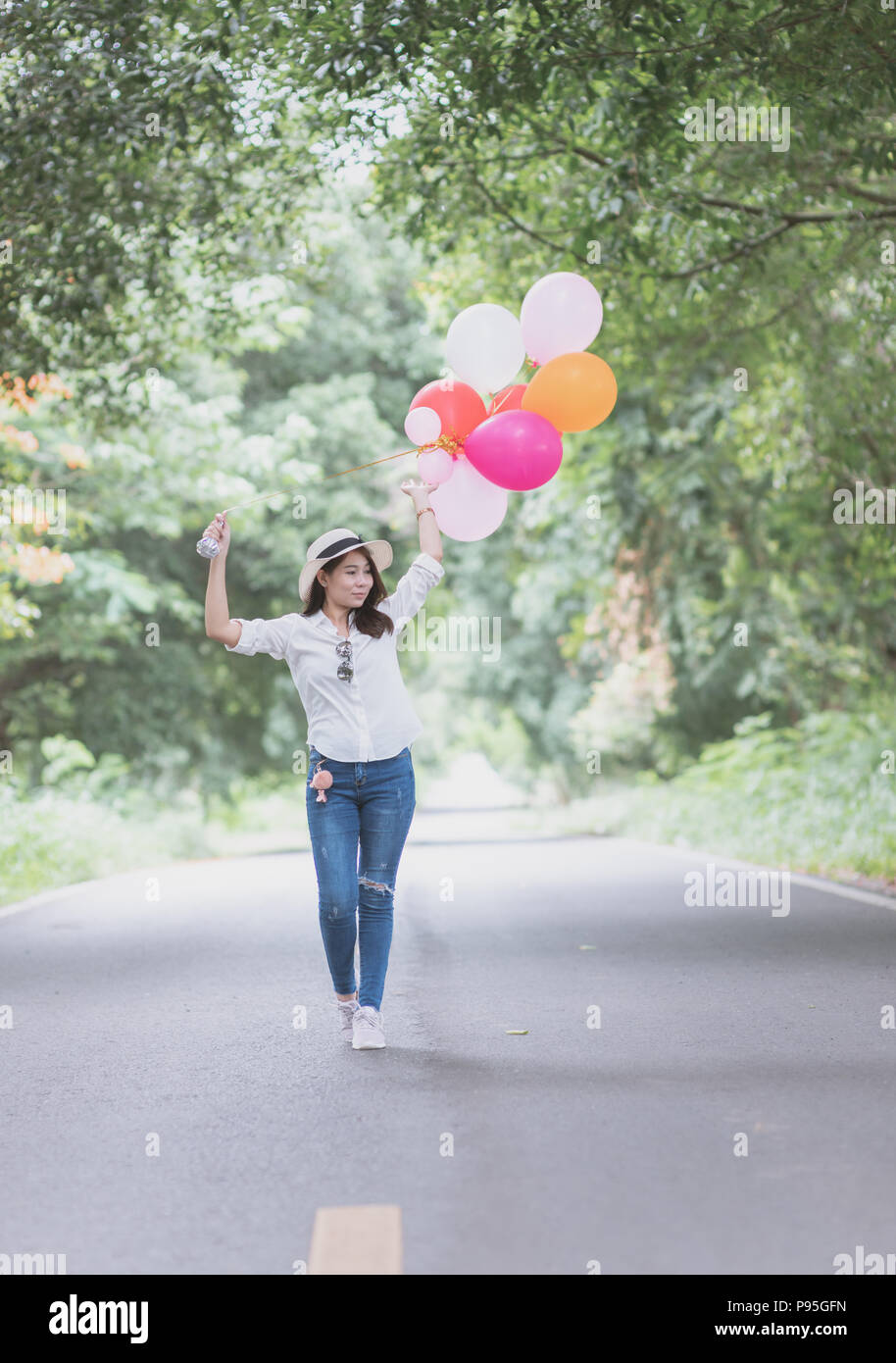 Young hipster girl holding balloon walk on the road, Freedom and ...