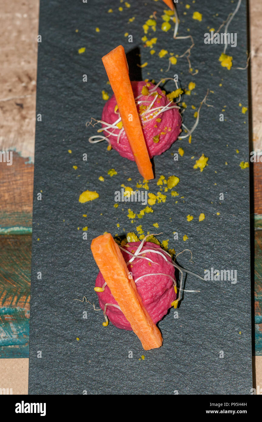 beet humus, carrot in slices, slate dish Stock Photo - Alamy