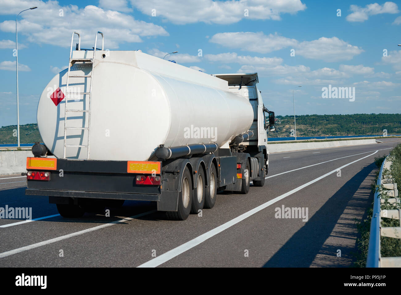 fuel truck rides on highway, white blank cistern for oil, rear view ...