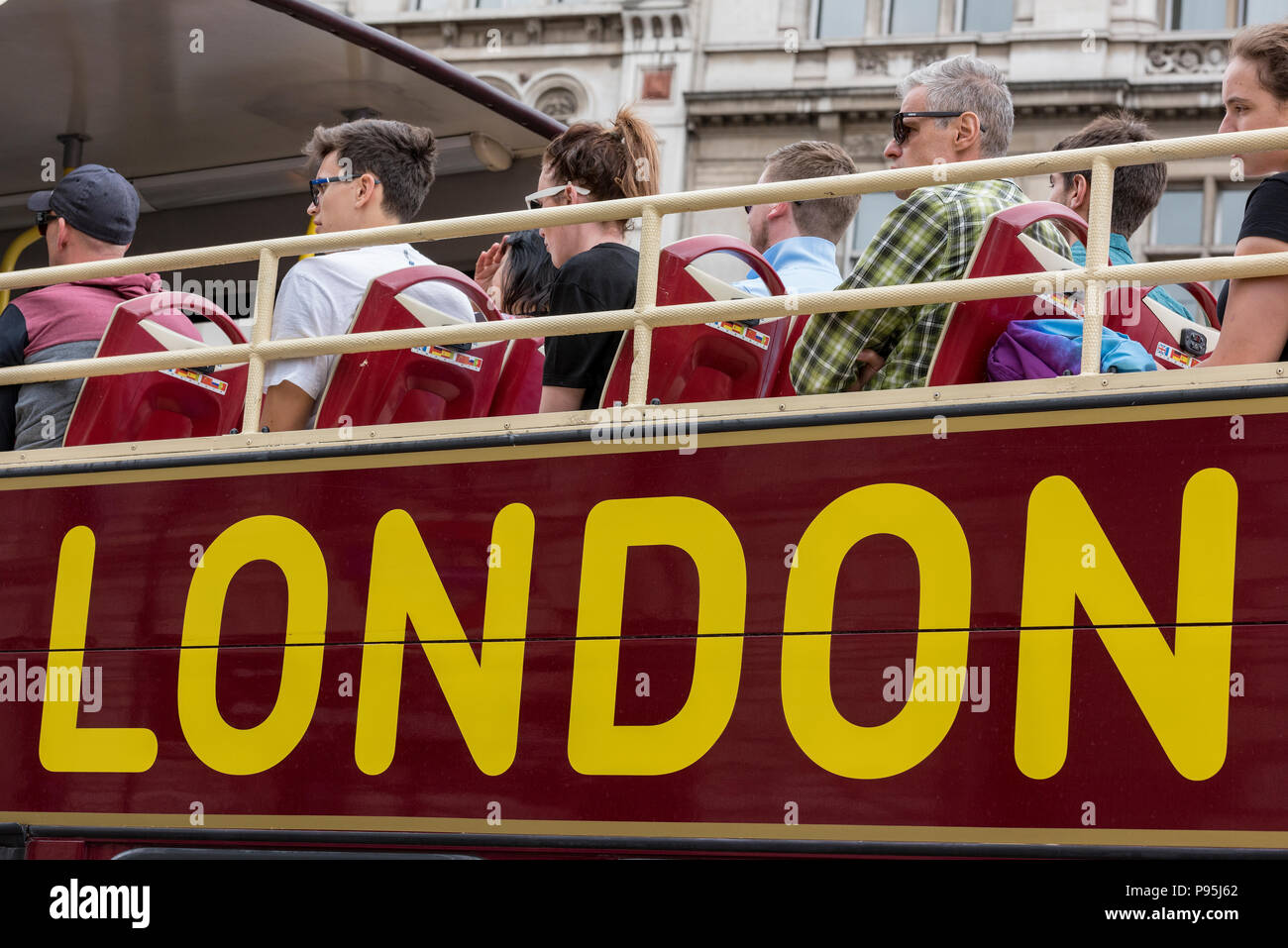 tourists on an open topped double decker bus in central London ...