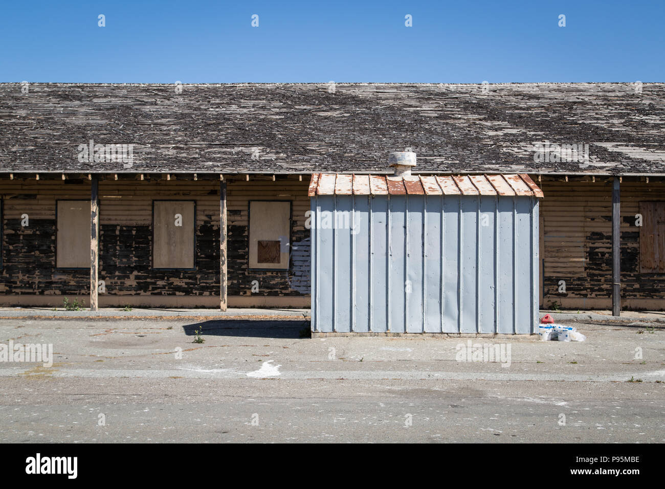 A storage unit in front of a boarded up military building on Naval ...
