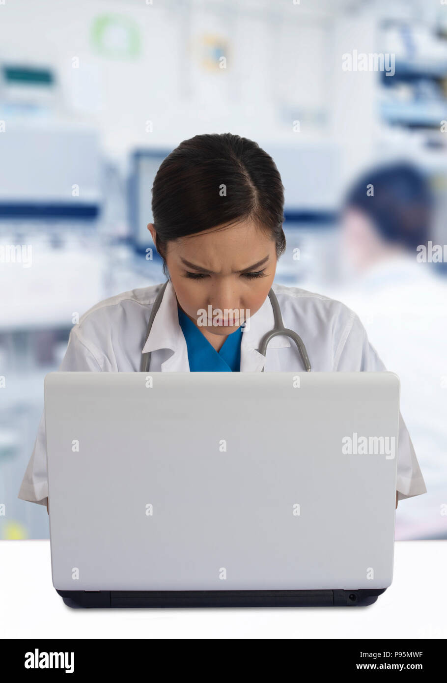 Female doctor working so serious with laptop computer in hospital Stock ...