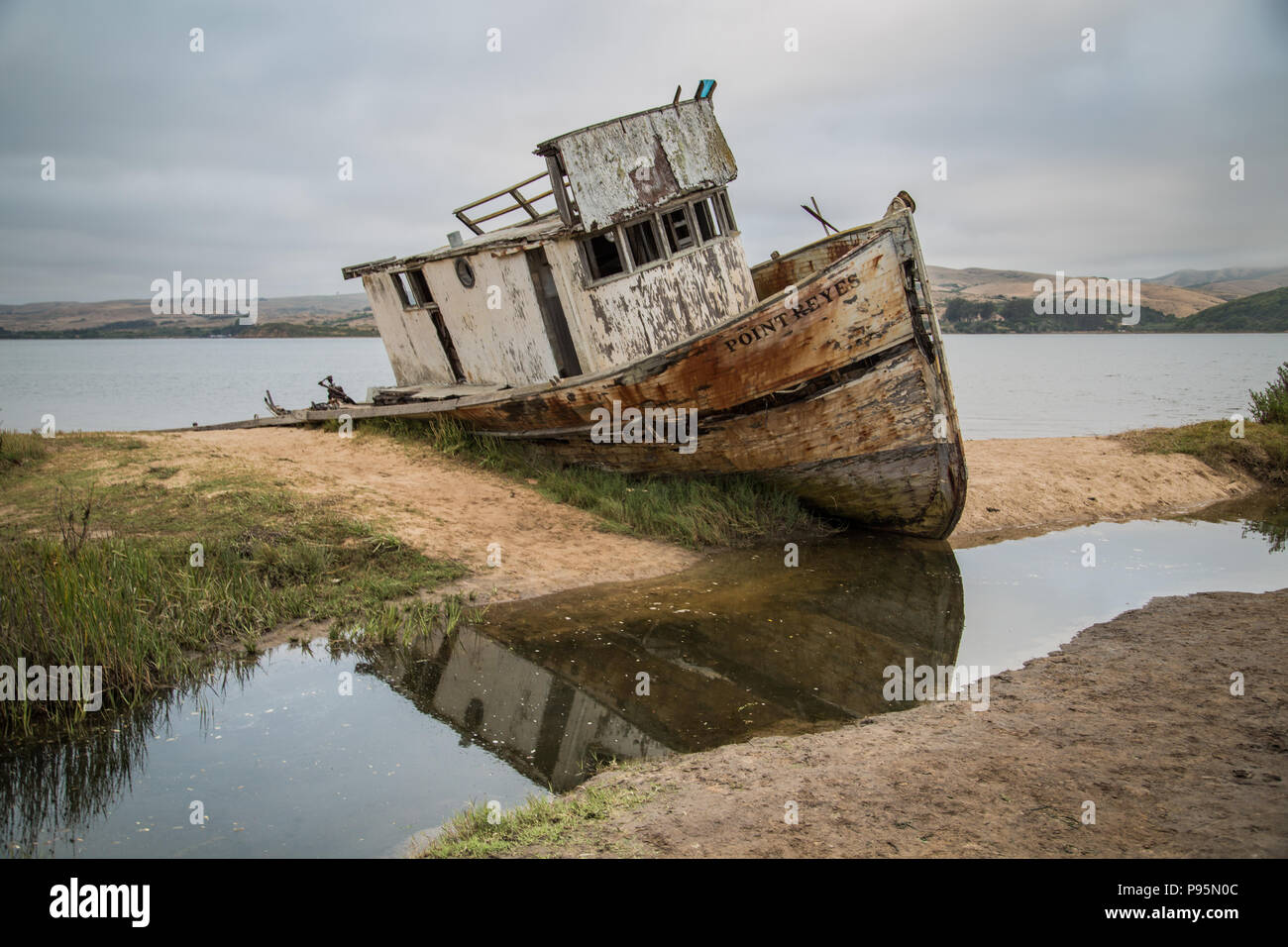A side view of the Point Reyes shipwreck and its reflection, an ...