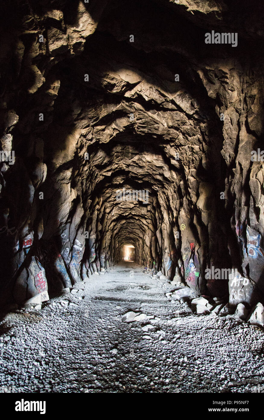 The rough rock walls of one of the abandoned Donner Pass tunnels ...